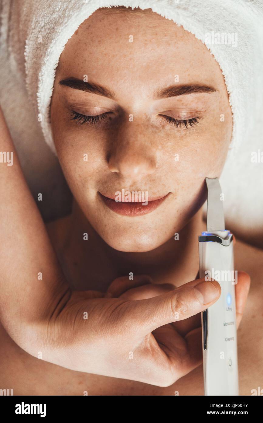 Close-up portrait of woman face receiving ultrasound cavitation facial ...