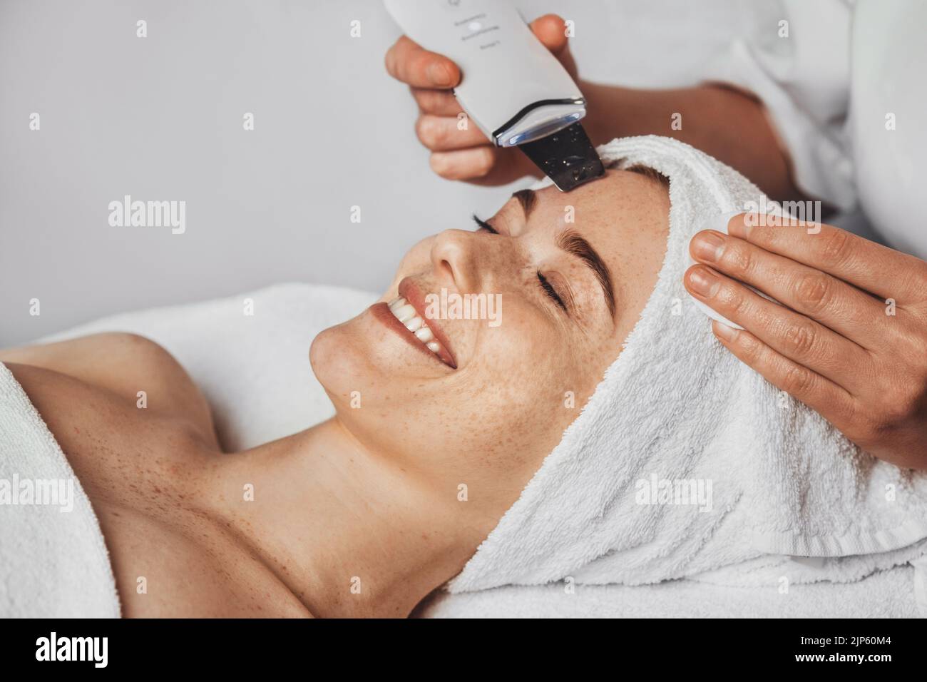 Close-up portrait of a woman face getting ultrasound apparatus facial ...