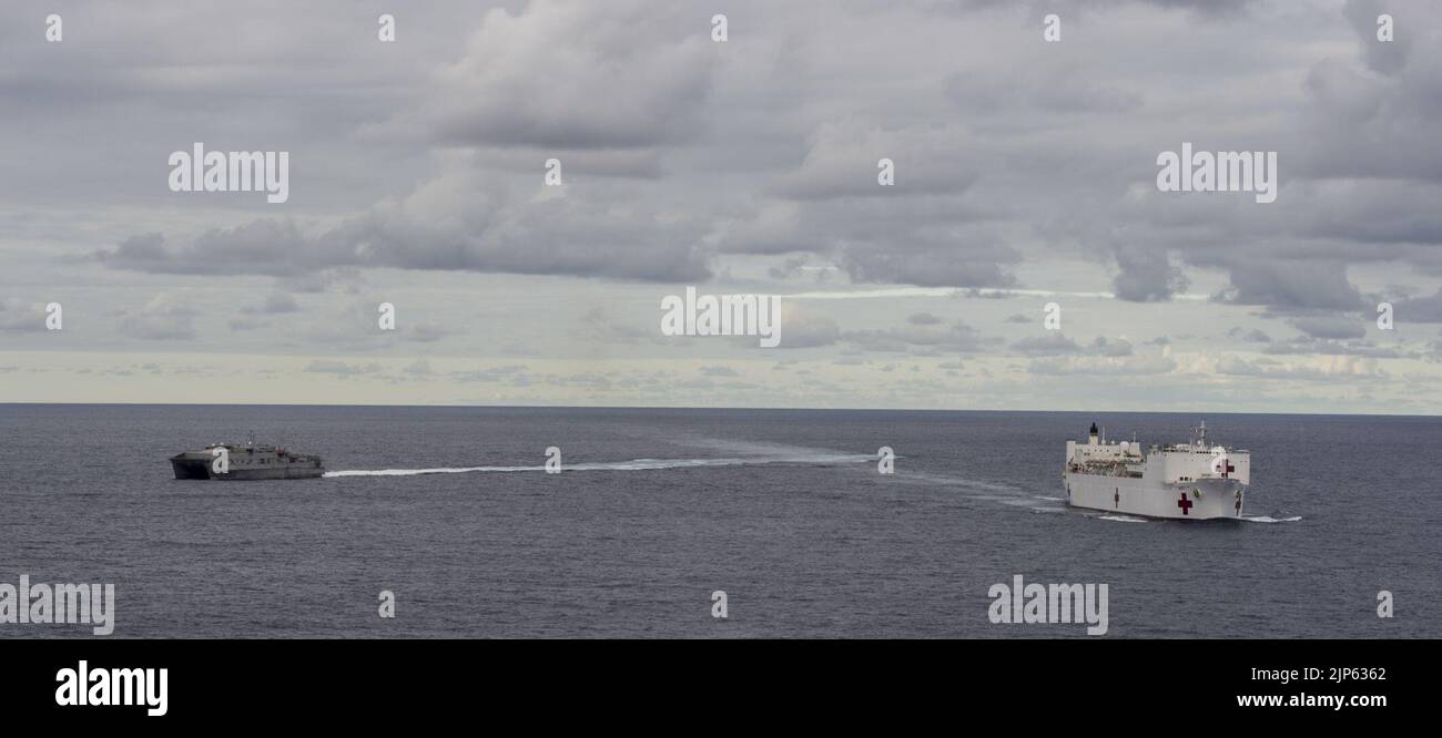 The Military Sealift Command hospital ship USNS Mercy (T-AH 19) and the ...