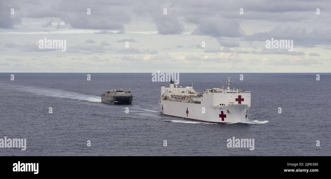 The Military Sealift Command hospital ship USNS Mercy (T-AH 19) and the ...