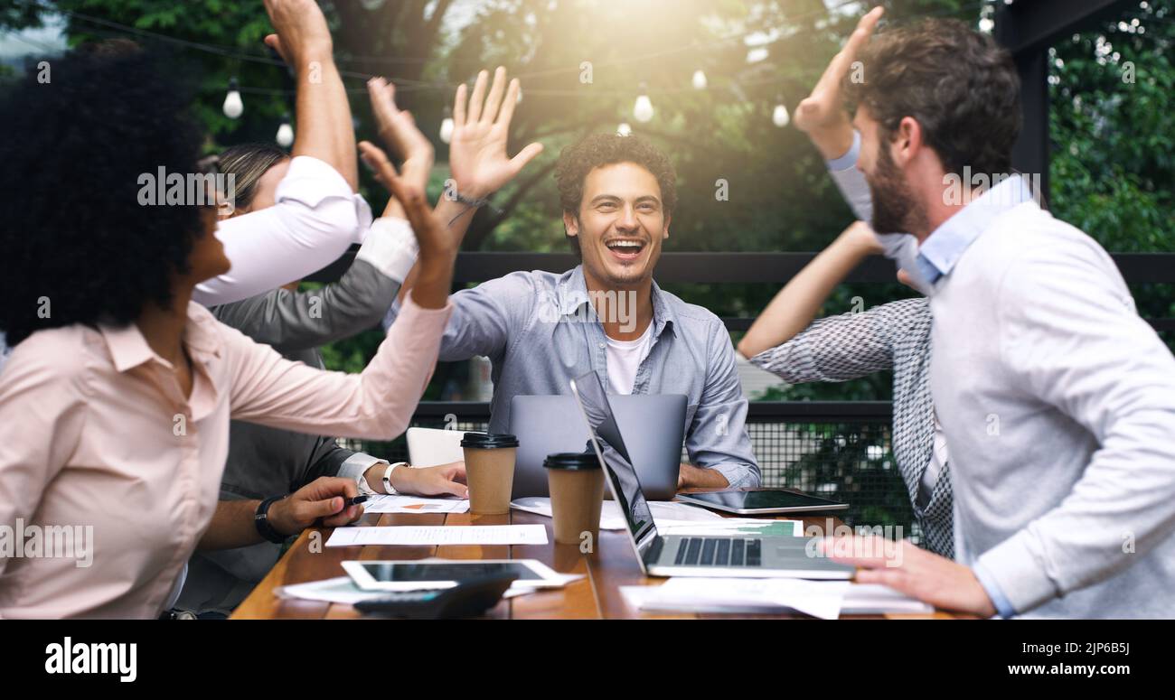 And thats how you do it as a team. a group of businesspeople high ...