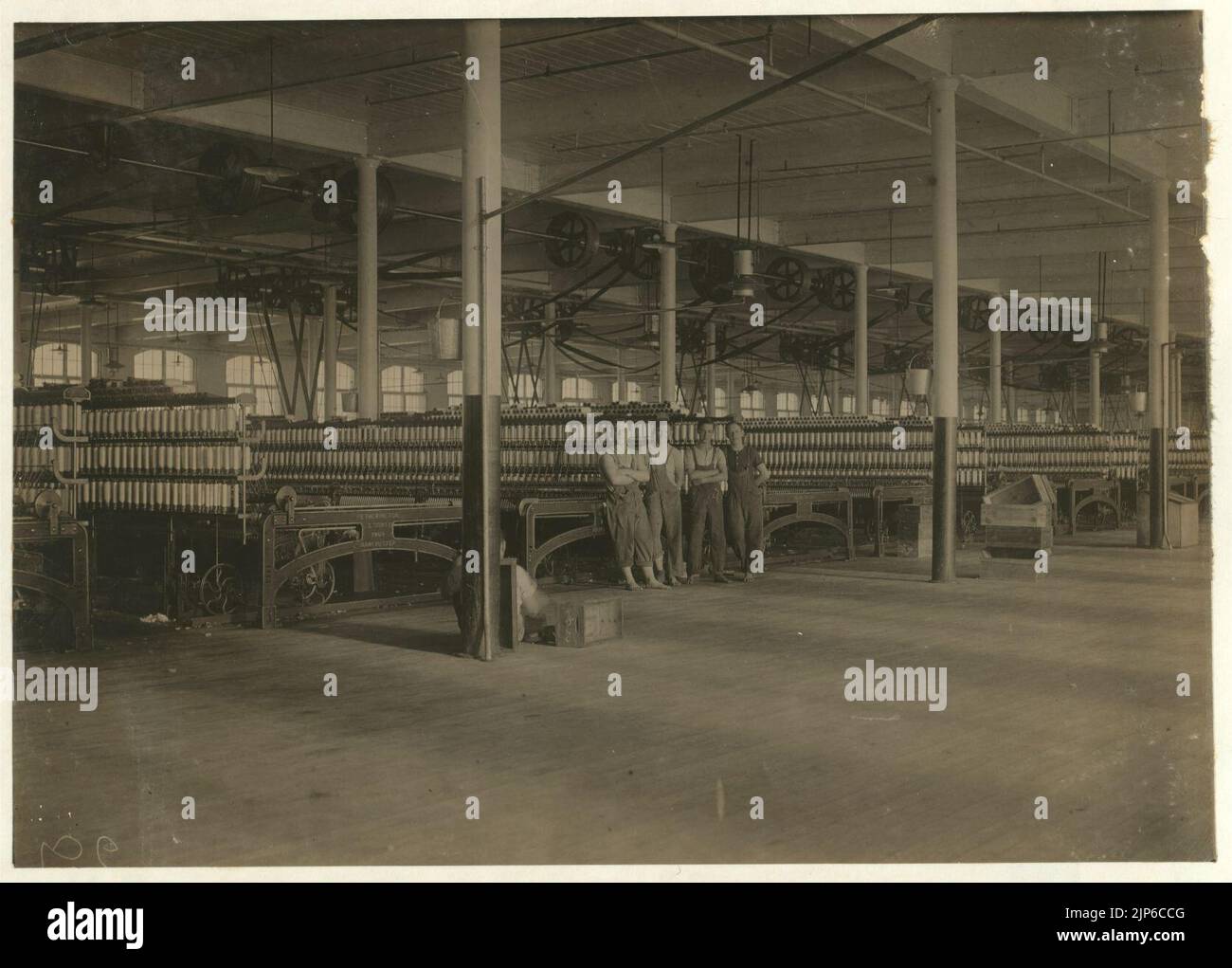 The Mule Room in the New Bedford Cotton Mill. Some small boys are ...