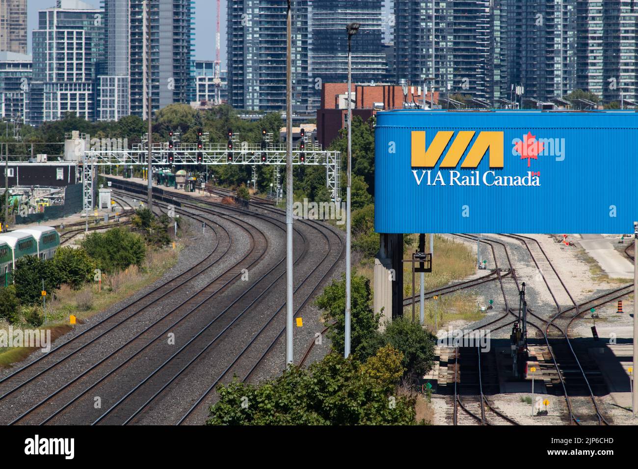 The VIA Rail Canada logo is seen on a structure in a large rail yard in ...