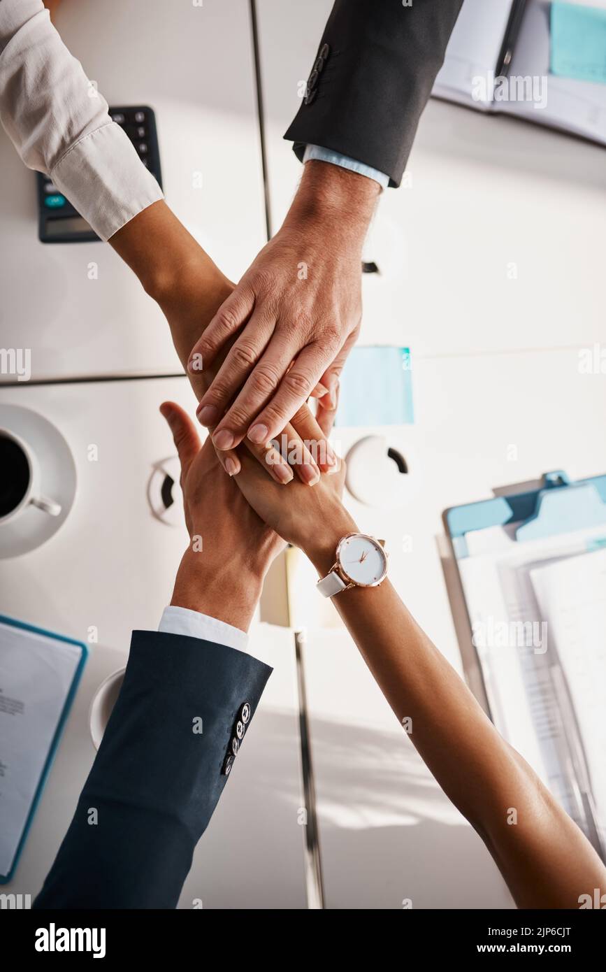 United to gain success together. High angle shot of unrecognizable ...