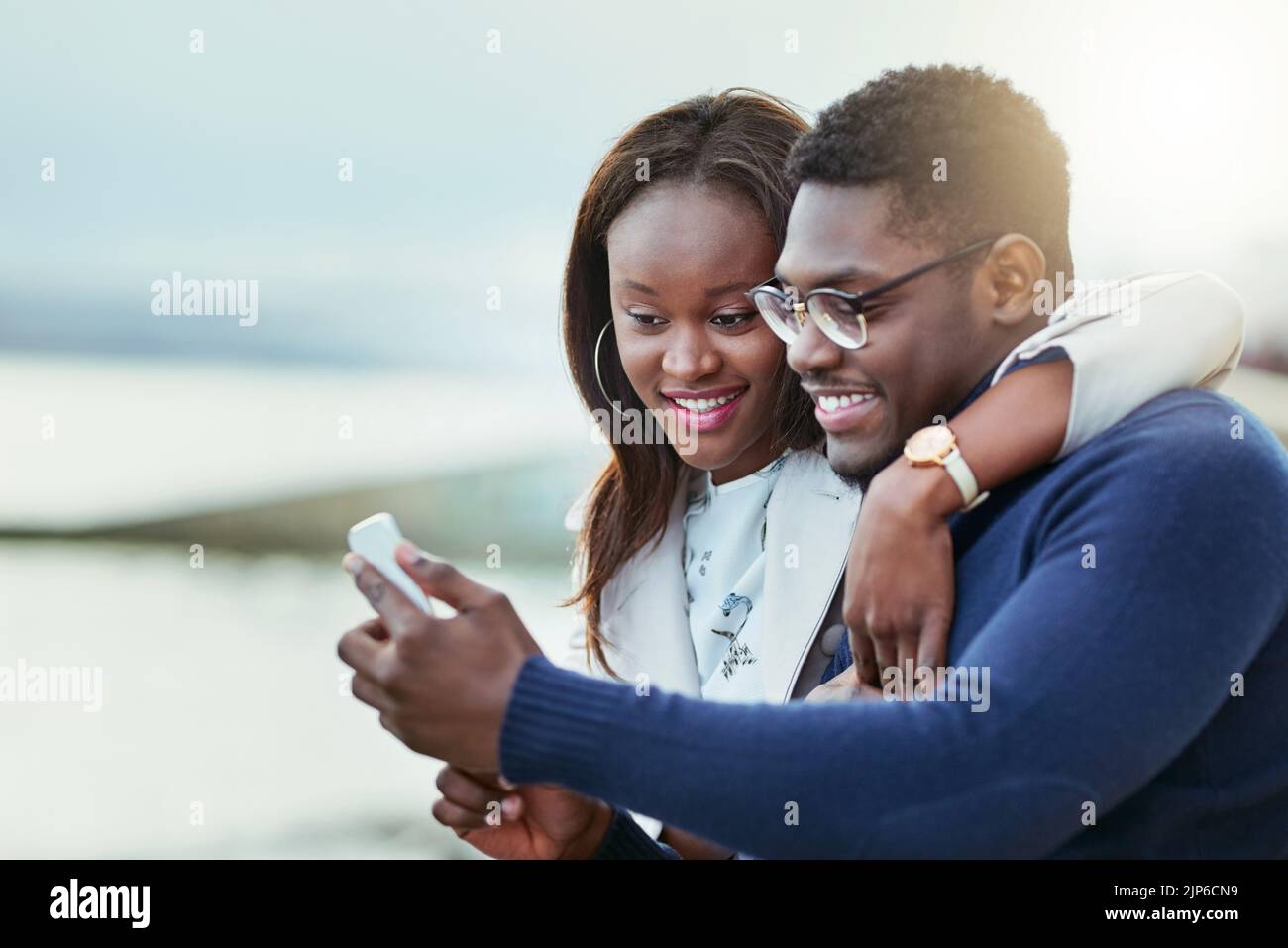 Love means sharing everything together. an affectionate young couple ...