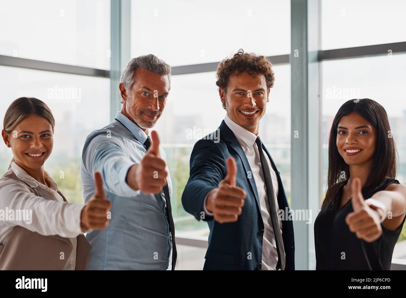 Thumbs up to creating a successful business. corporate businesspeople ...