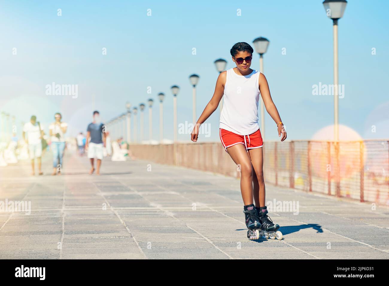 How I like to roll. an attractive young woman rollerblading on a ...