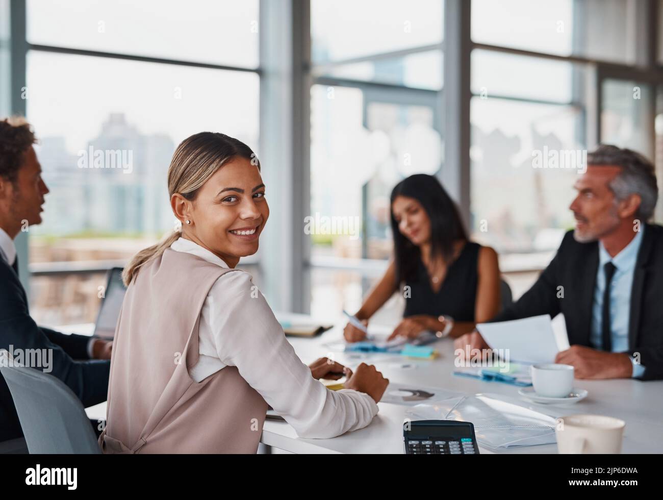 Brainstorming in the boardroom. corporate businesswoman looking back ...