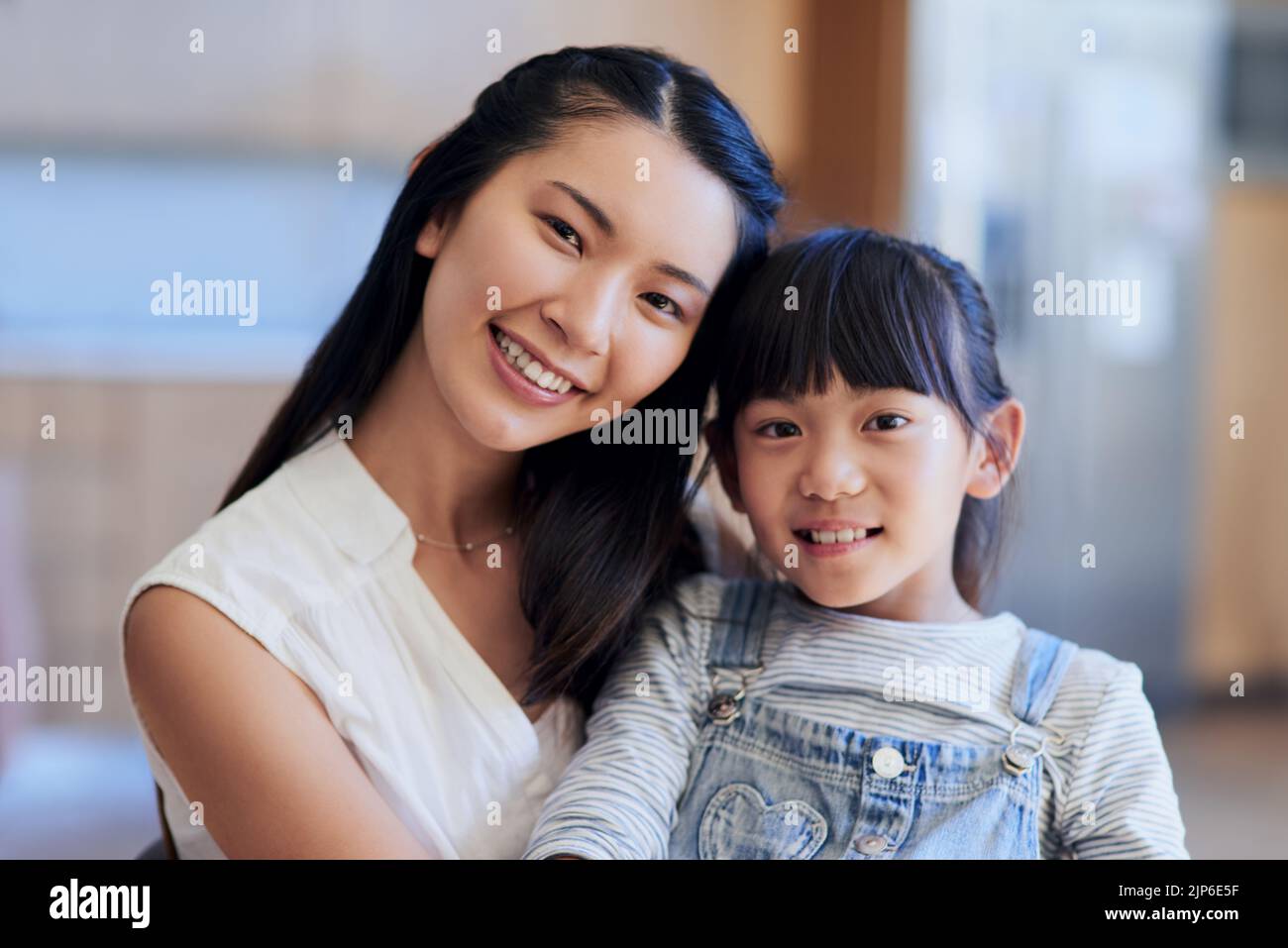 Shes definitely a mommys girl. Portrait of a mother and her little daughter bonding together at ...