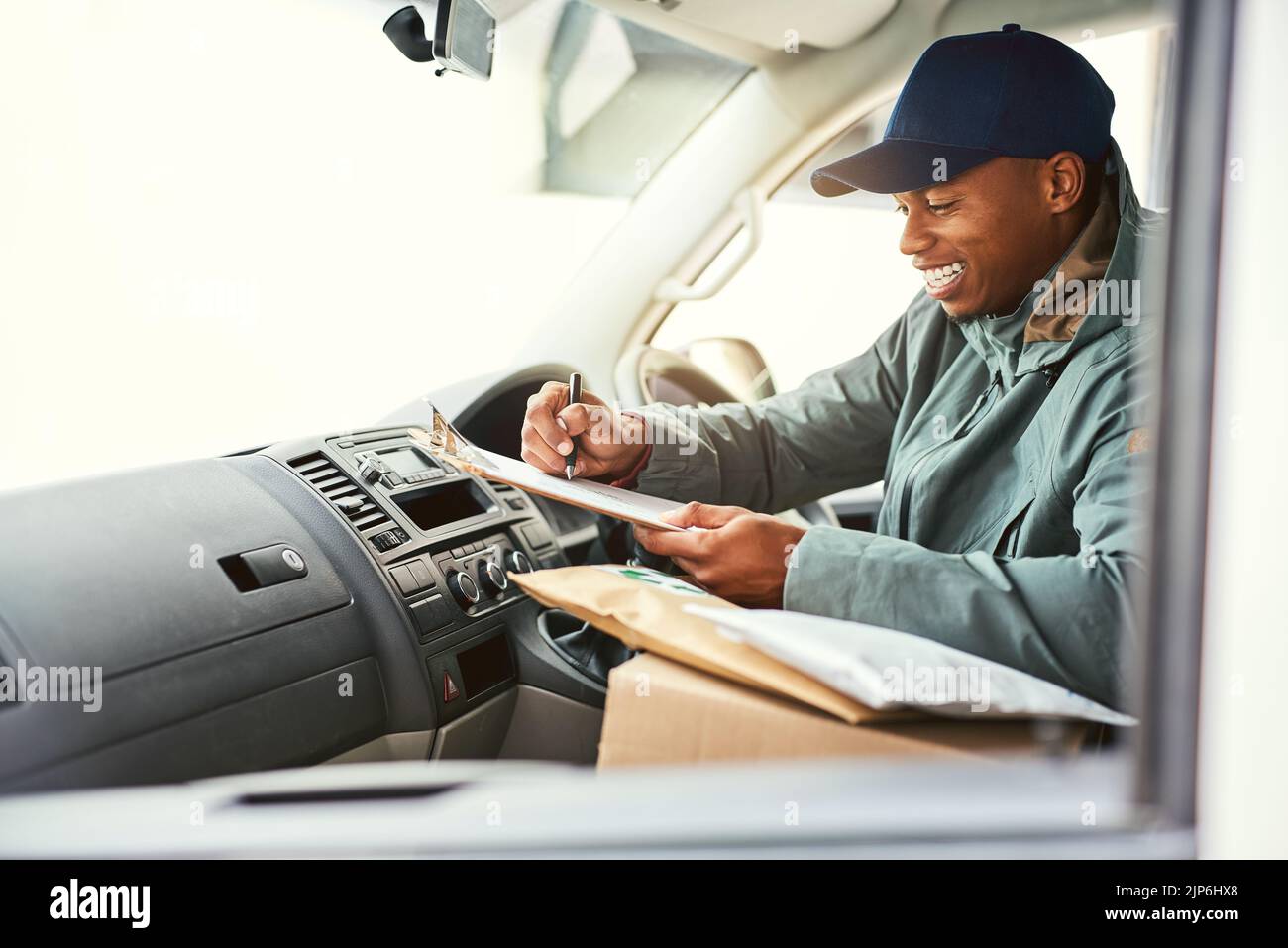 He knows how to run a successful delivery schedule. a courier writing ...