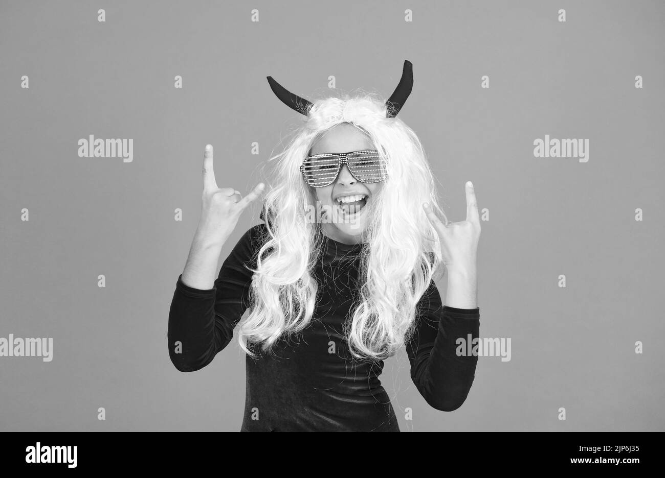 happy devil kid with party glasses and white hair wear horns costume of ...