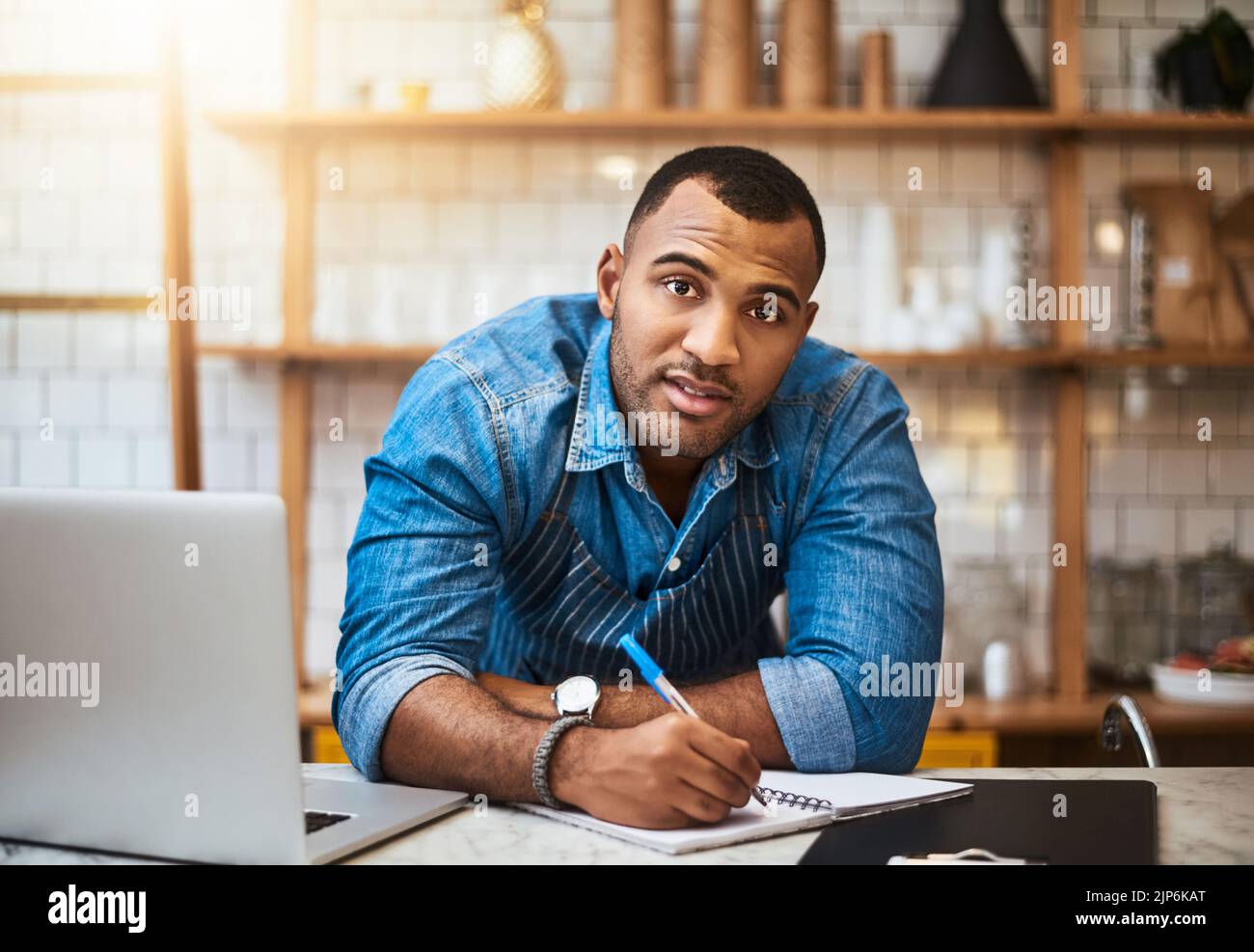 Coffee shops have paperwork too. Cropped portrait of a handsome young ...