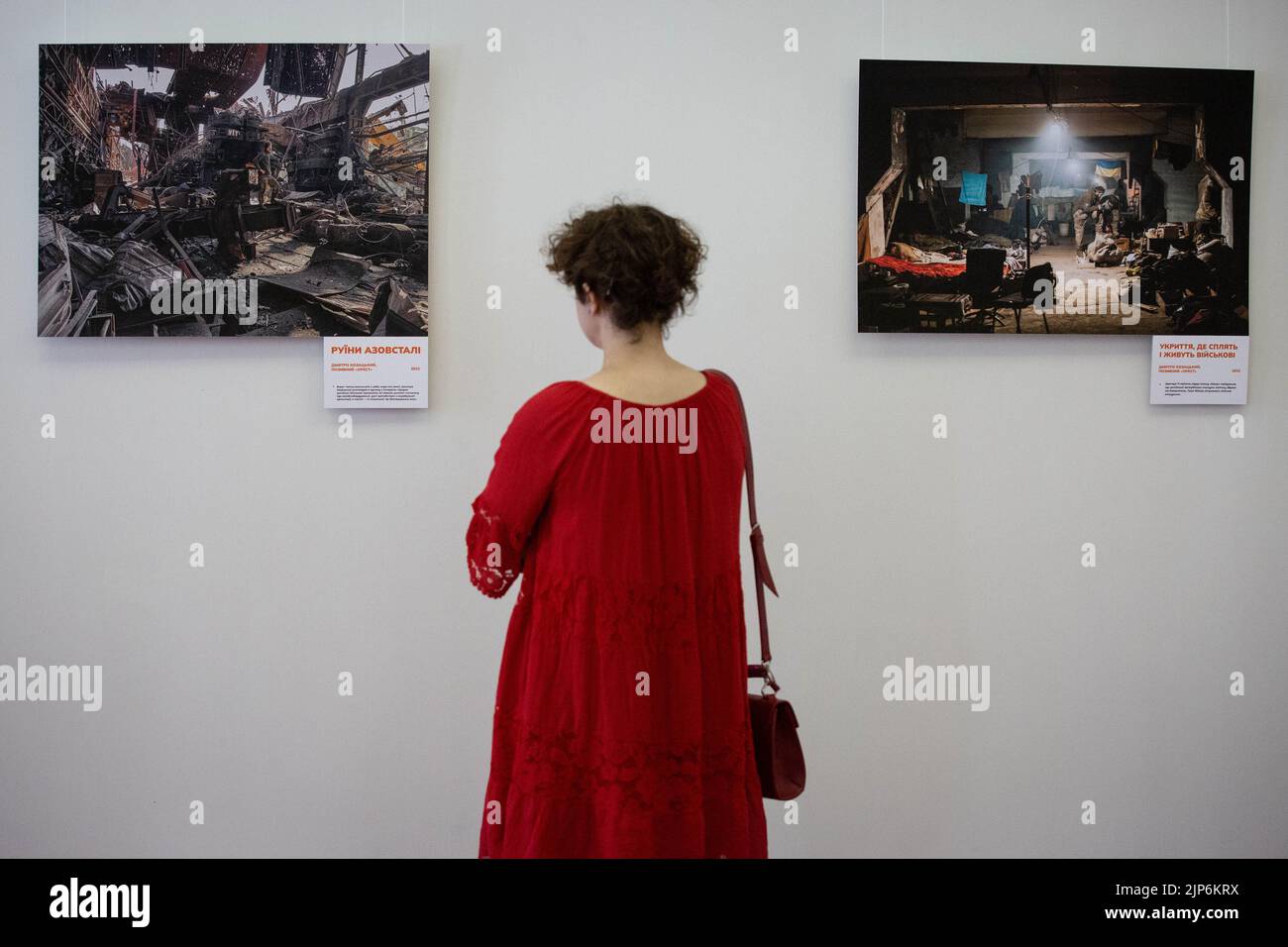 Kyiv, Ukraine. 14th Aug, 2022. A woman watches pictures by Azov soldier ...