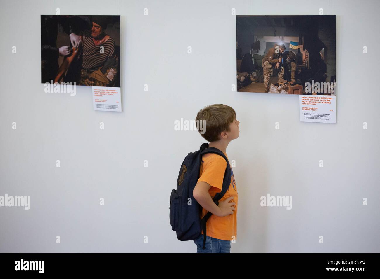 A boy watches pictures by Azov soldier-photographer Dmytro 'Orest ...