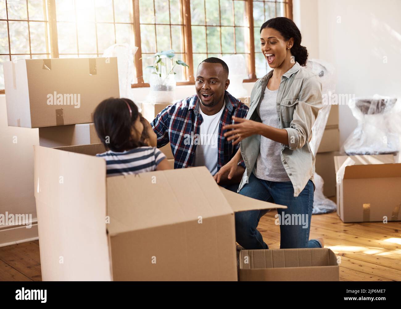 Its a fun time to play hide and seek. a family having fun while moving ...