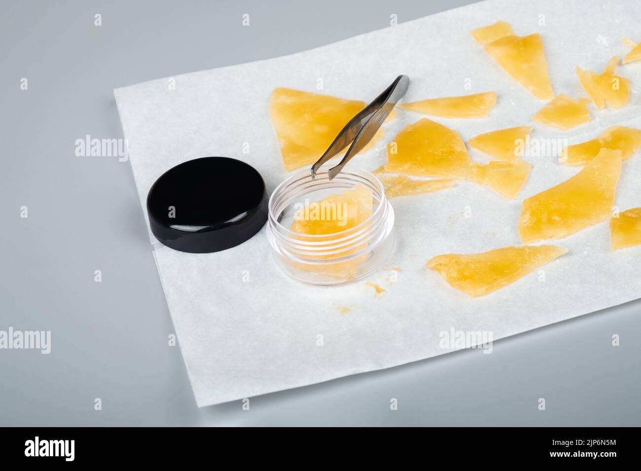 smoking cannabis extract, piece golden resin shatter Stock Photo - Alamy