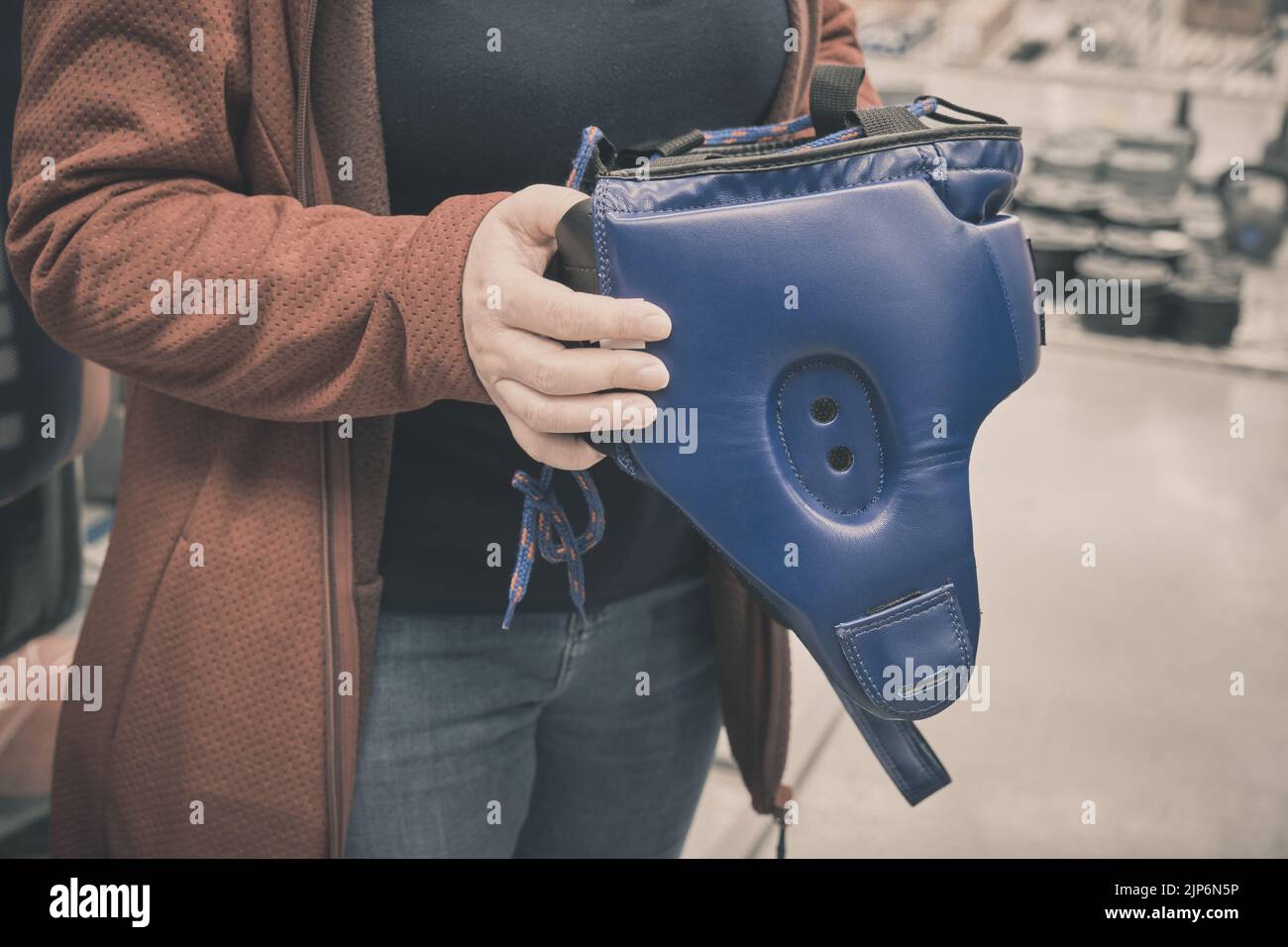 Woman in store chooses to buy blue helmet to protect your head during ...