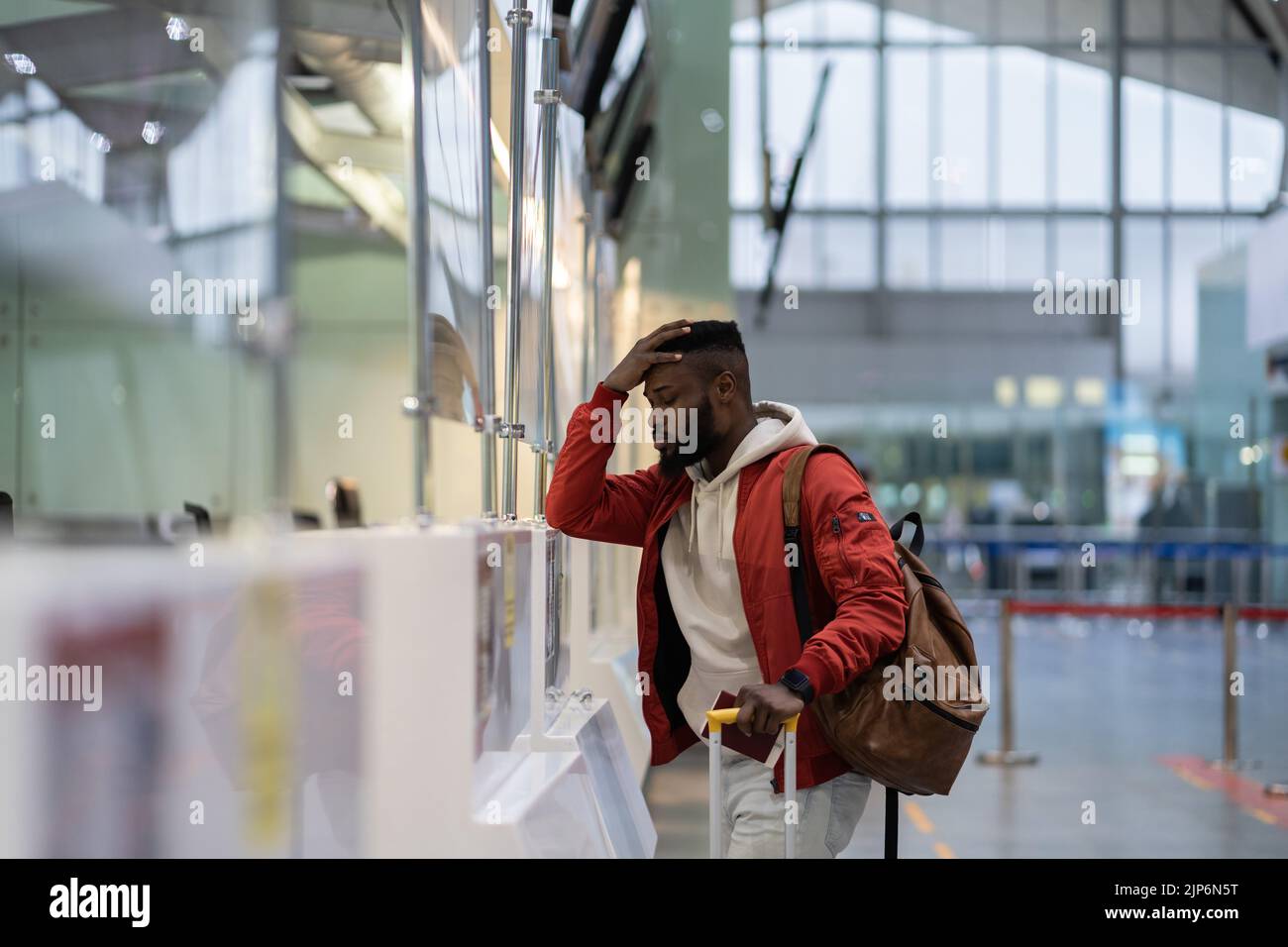 Frustrated sad young African man passenger having problems with check ...