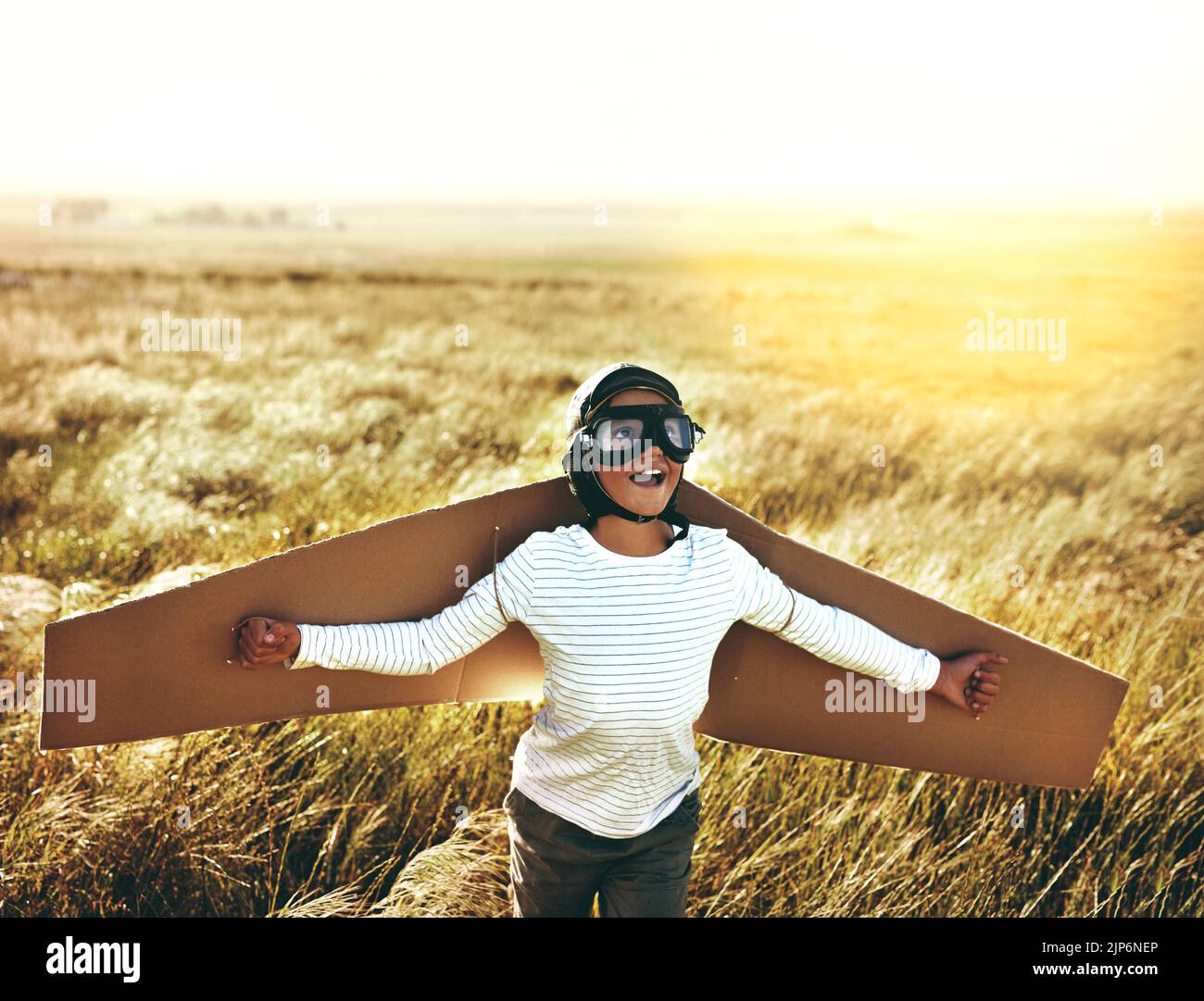 Let their imaginations take flight. a young boy pretending to fly with ...