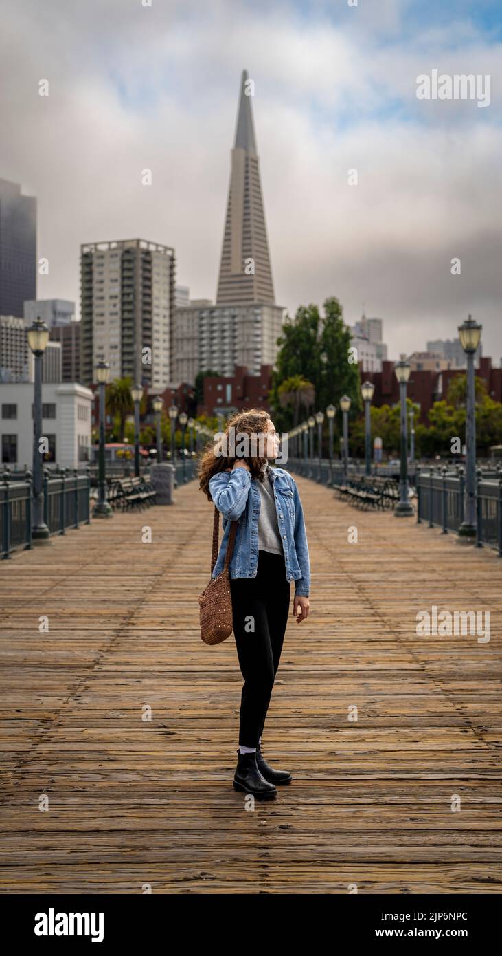 Naturally Posed Portrait of Standing Young Woman on Pier with San ...