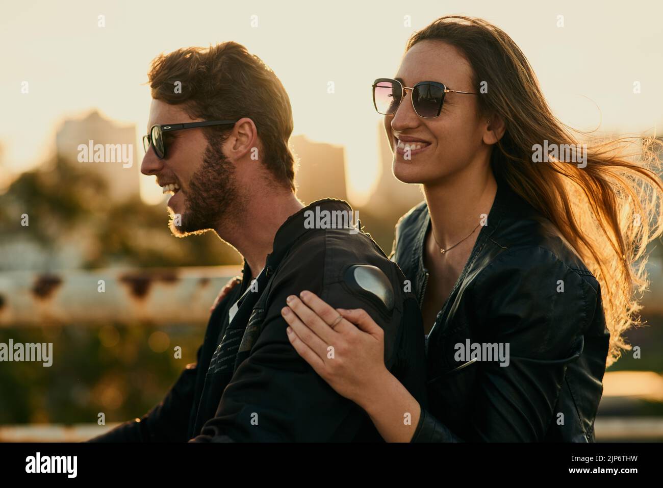 Go discover with your lover. a young attractive couple riding a scooter ...