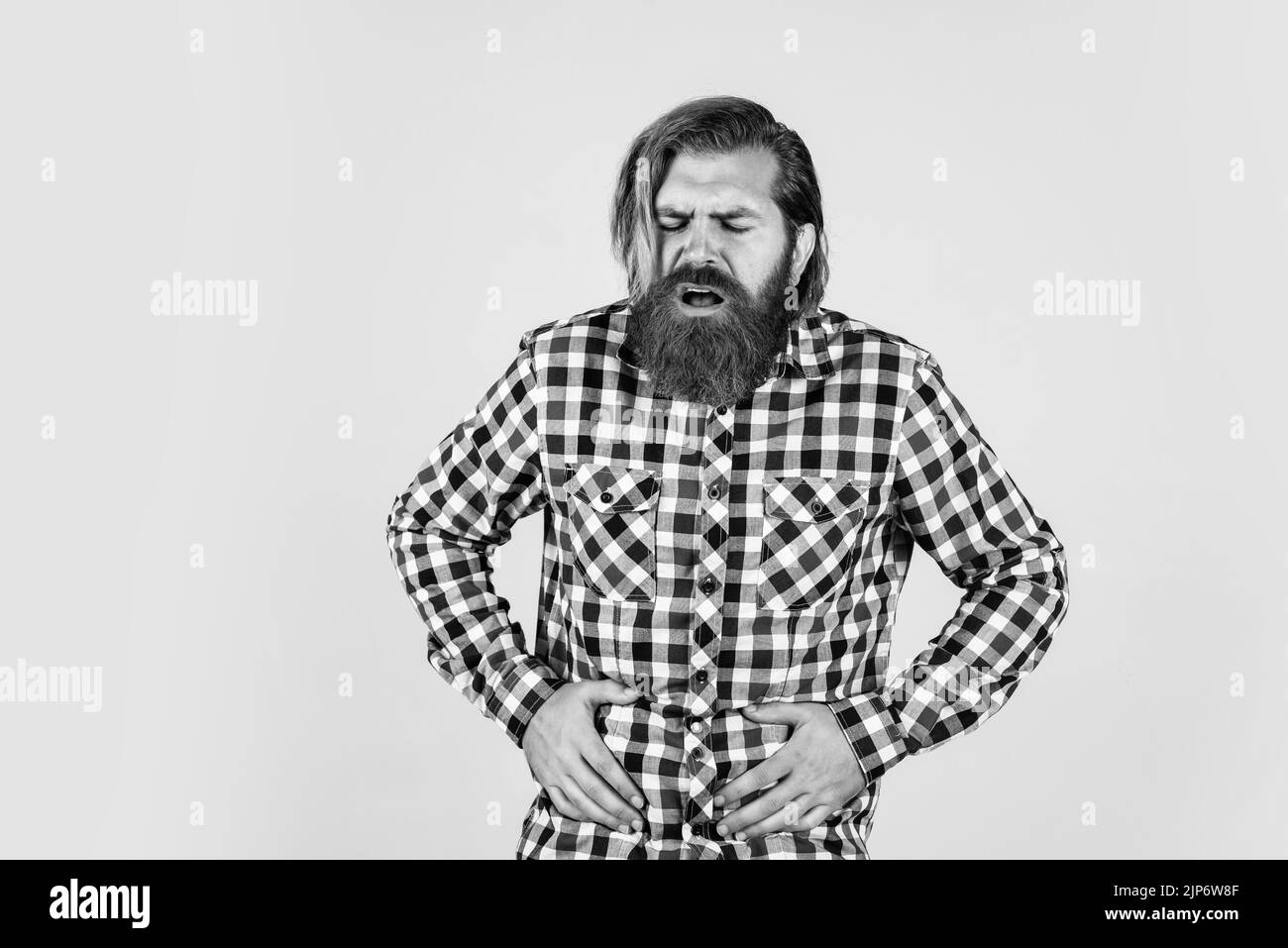 hurt handsome bearded guy with unshaven face and stylish hairdo wear ...