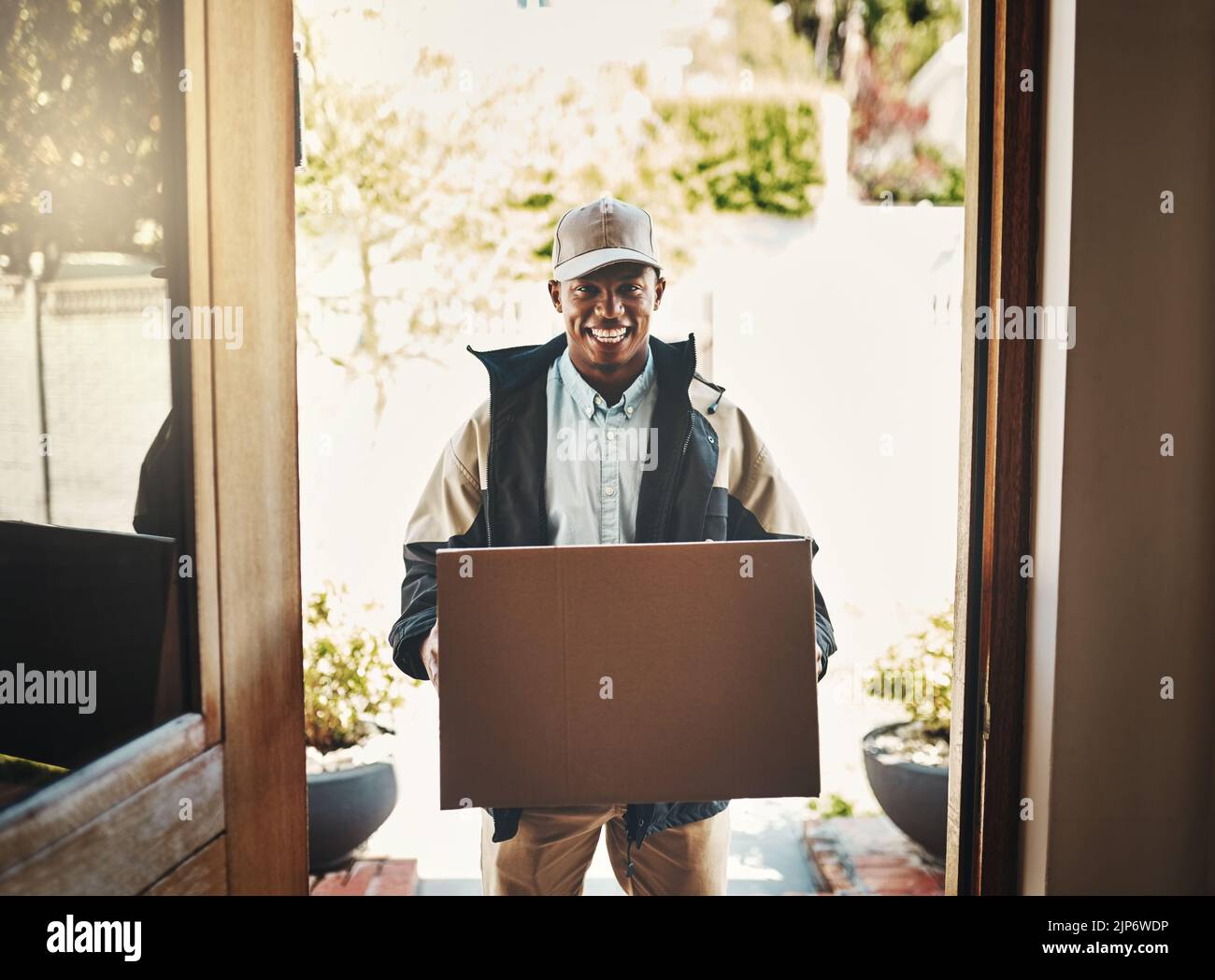 I have a delivery for you sir. Portrait of a cheerful young deliveryman ...
