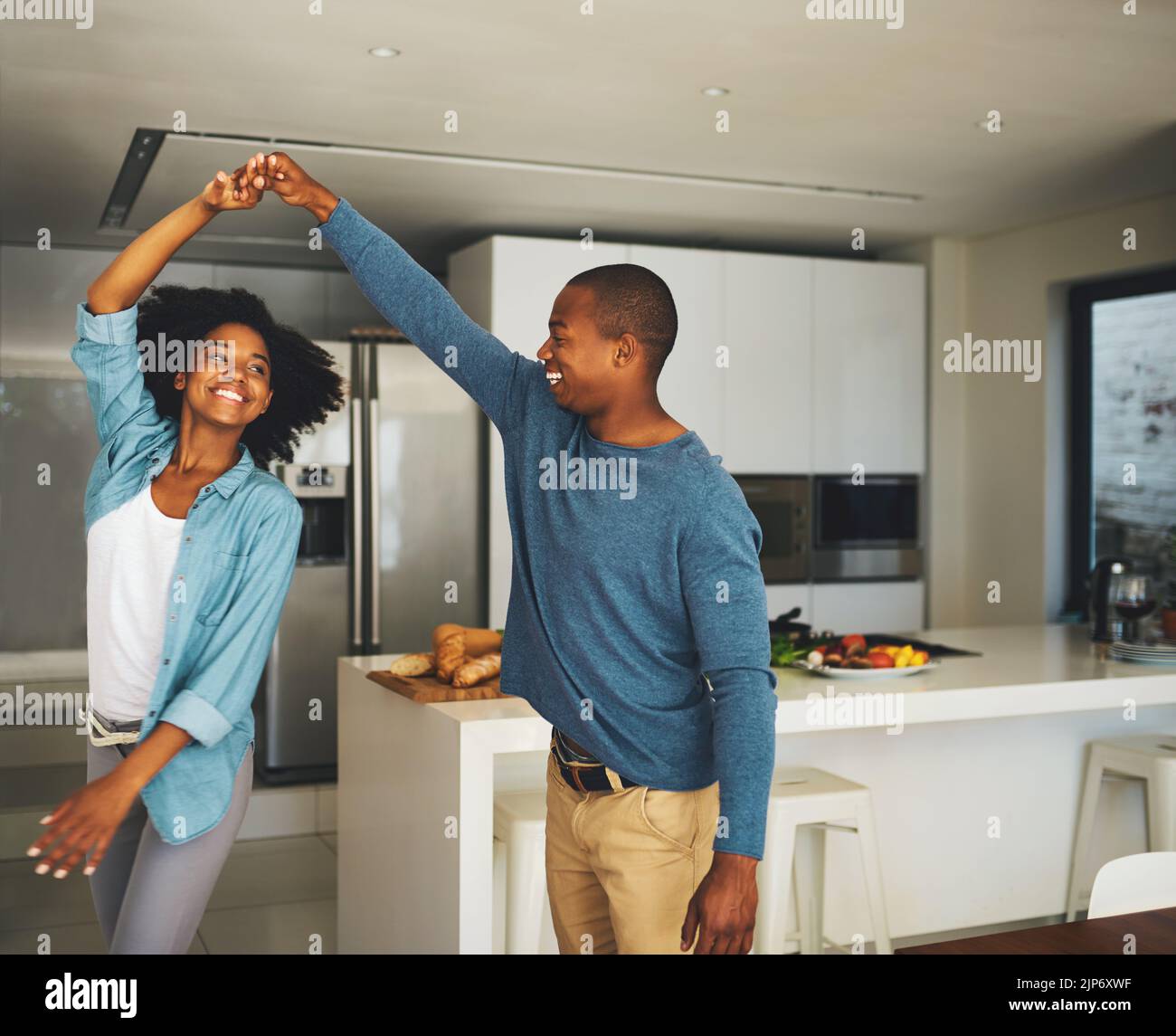 Spinning around. a cheerful young couple dancing together in the ...