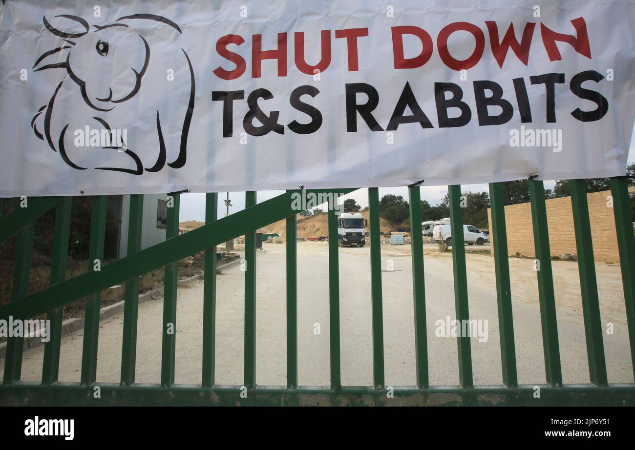 Animal rights activists hang a banner saying 'Shut Down T&S Rabbits' at ...