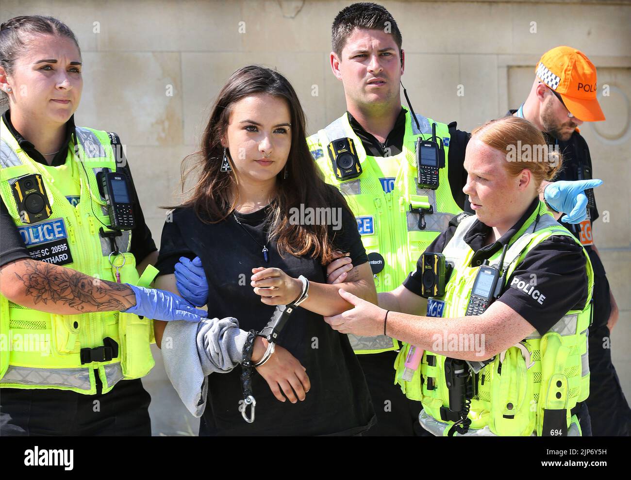 An animal rights activist is arrested after blocking the gates of ...