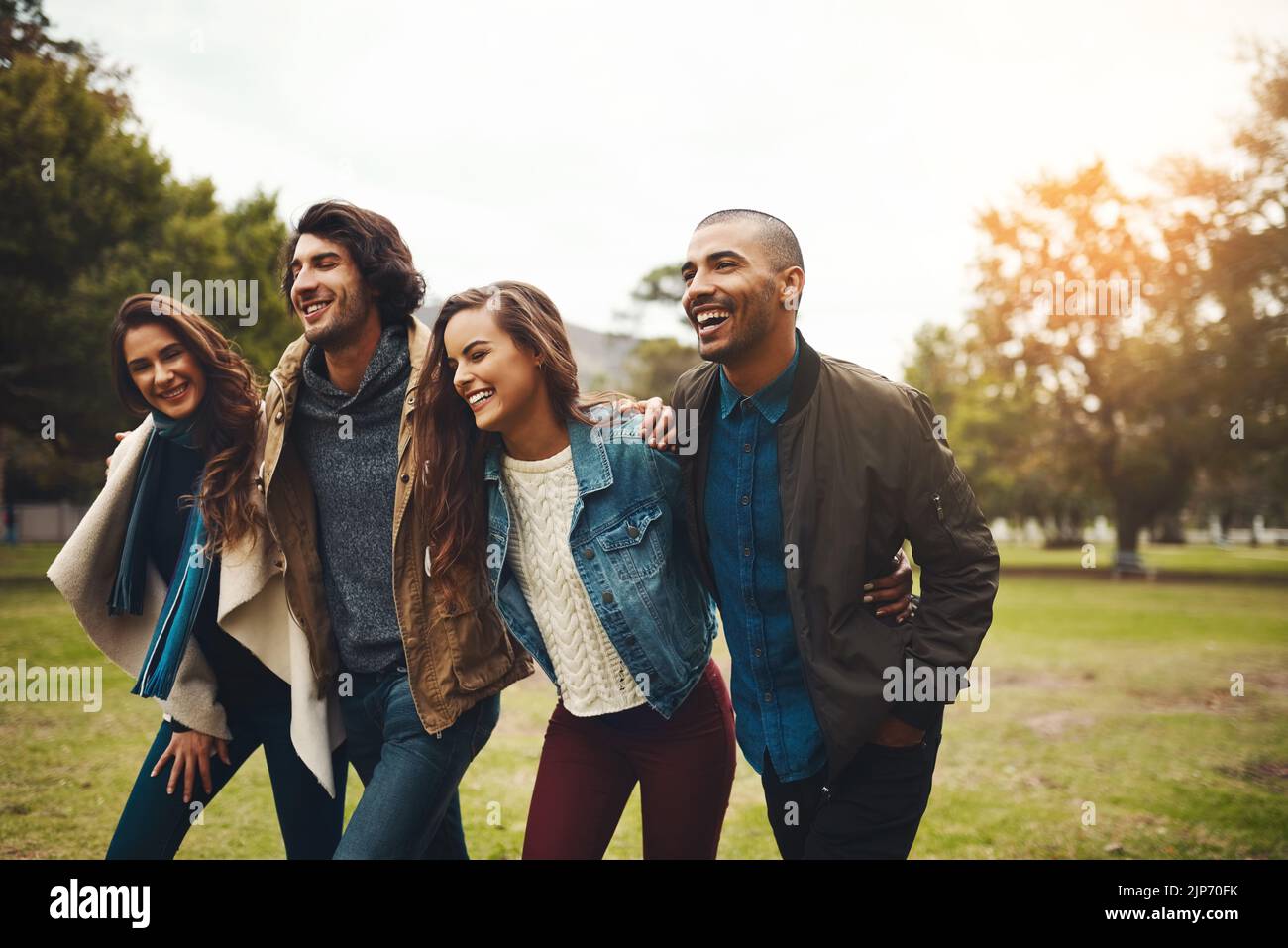 Lets get going. a group of cheerful young friends huddled together ...