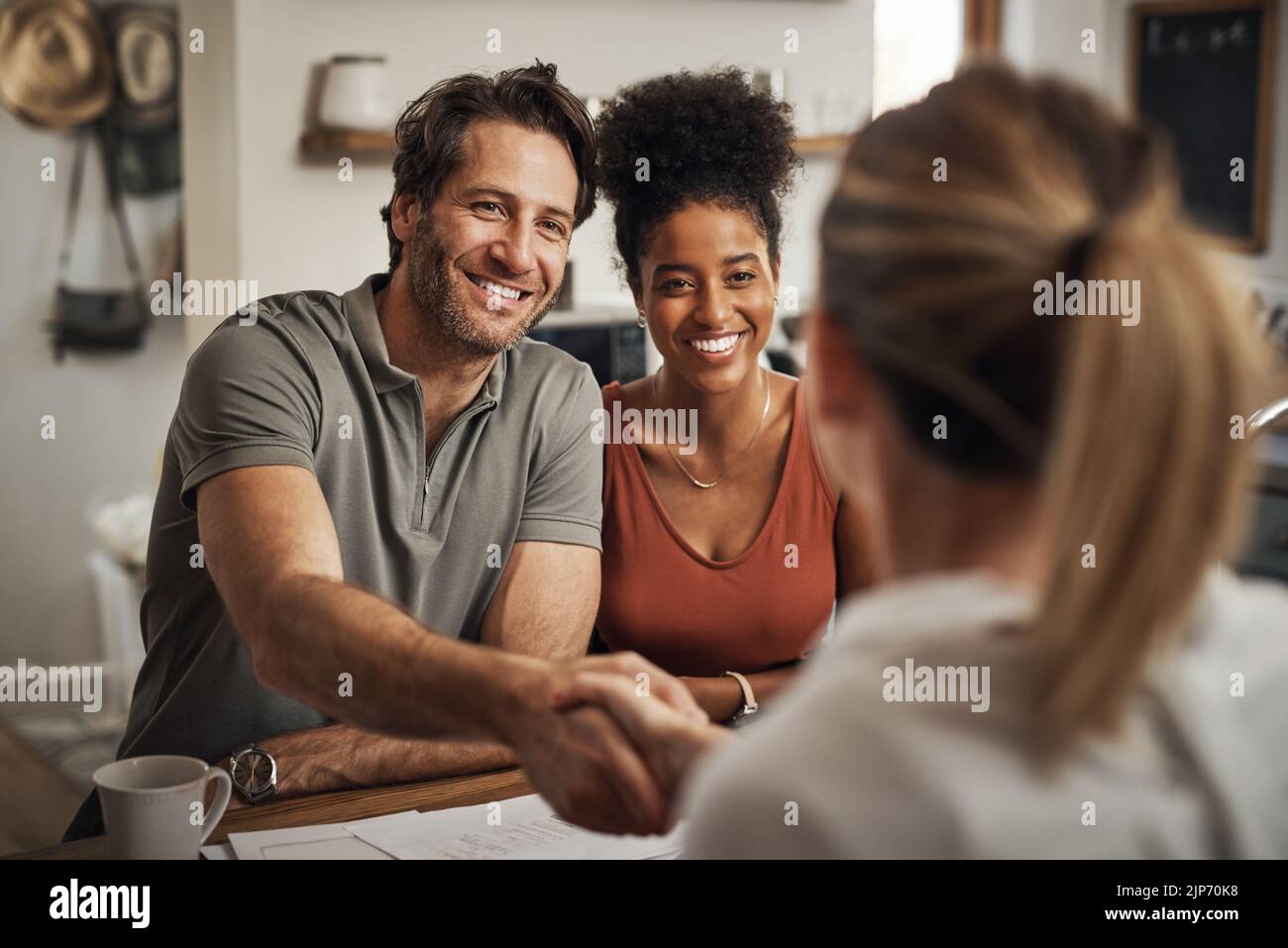 Married couple doing handshake with lawyer, legal advisor and attorney ...