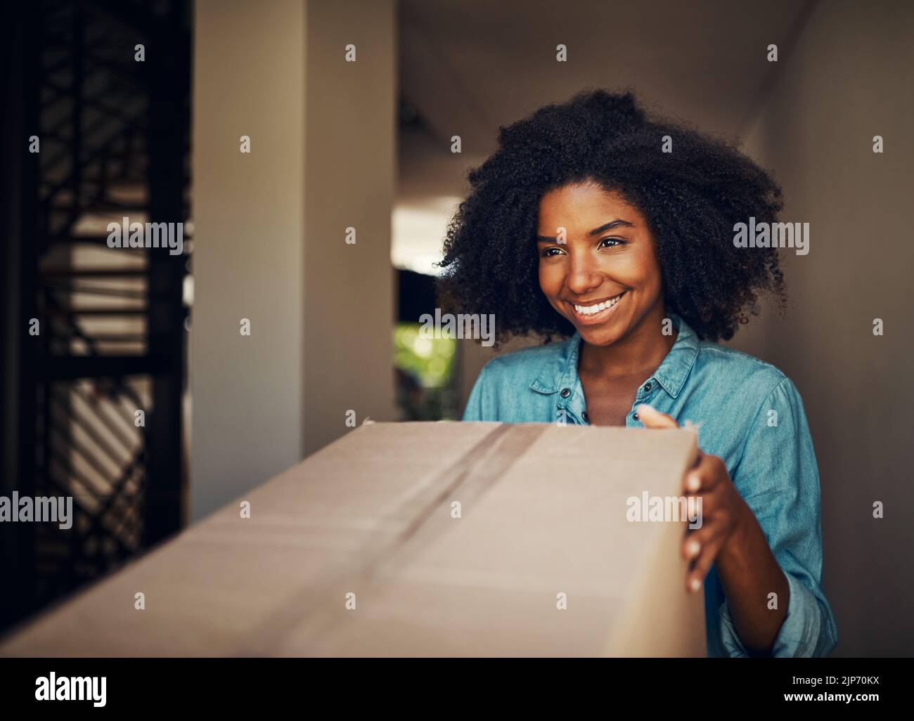 Thank you for the delivery. a cheerful young woman receiving a box ...