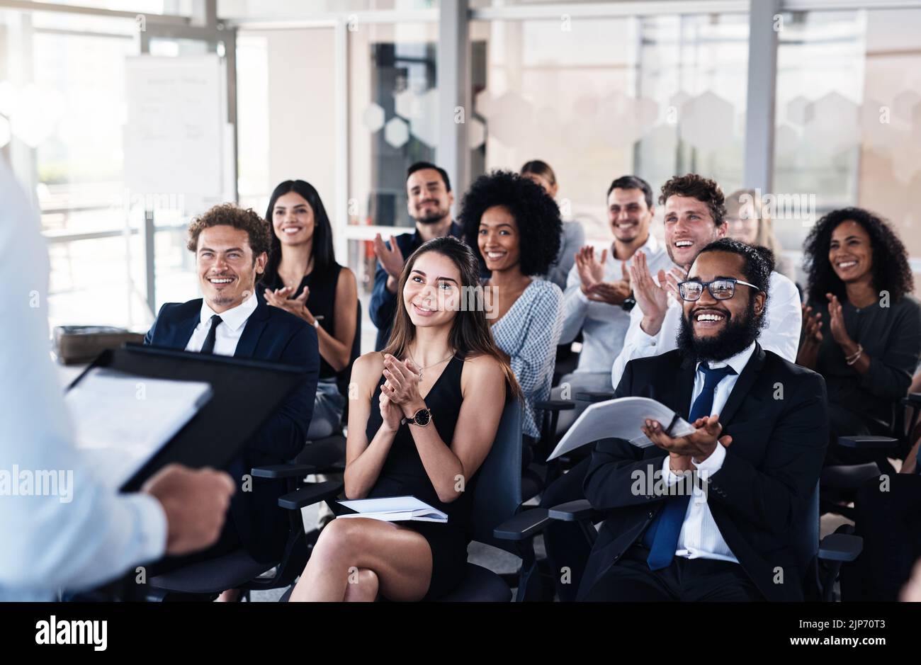 That was incredible. a group of businesspeople clapping during a ...