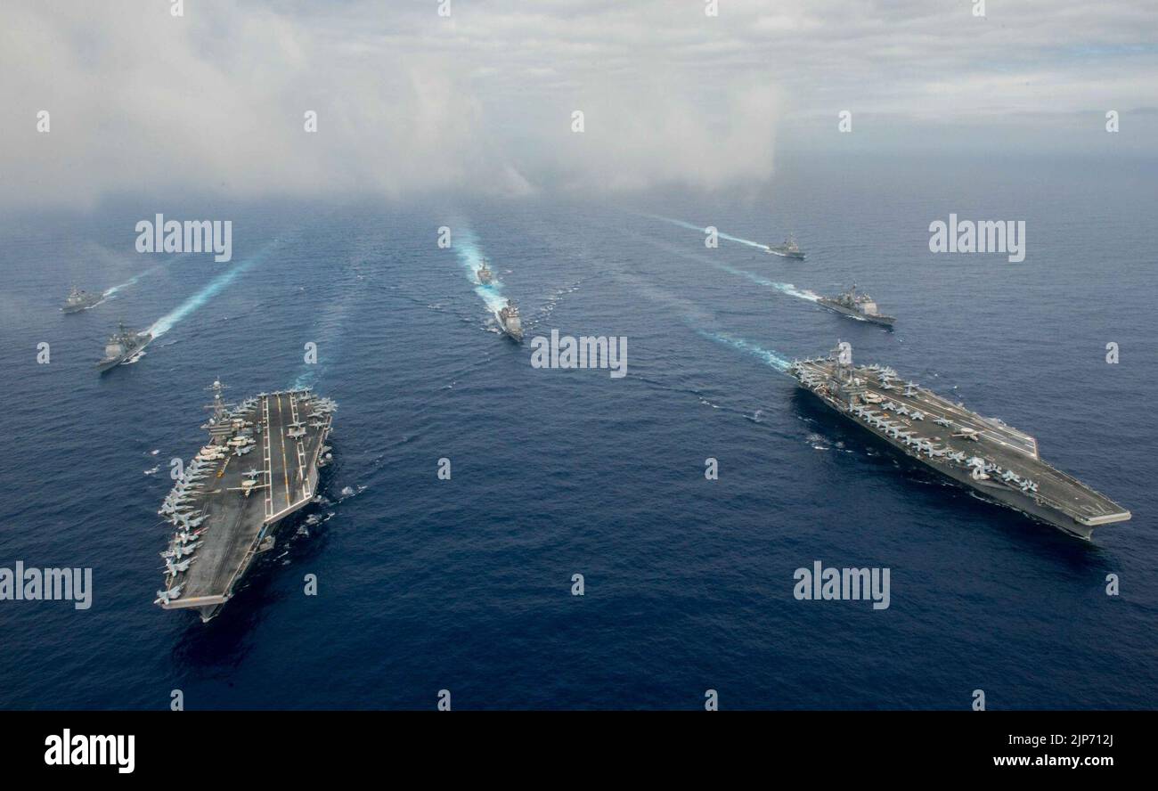 The Nimitz-class aircraft carriers USS John C. Stennis (CVN 74), left ...