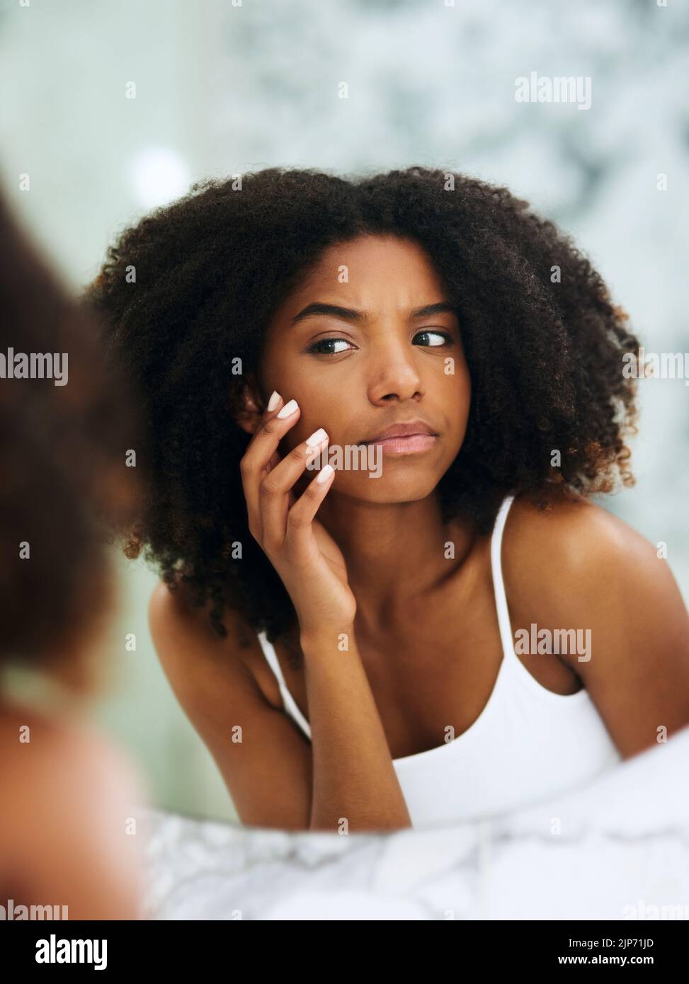 This pimple is so stubborn. an attractive young woman squeezing a ...