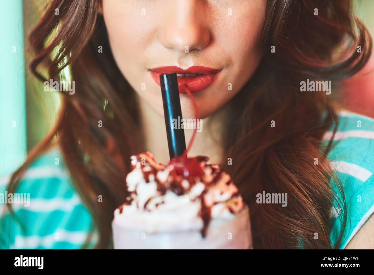 They make the best milkshakes in town. an unrecognizable woman drinking ...