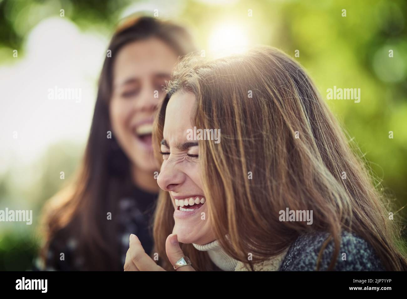 Two women laughing in park hi-res stock photography and images - Alamy