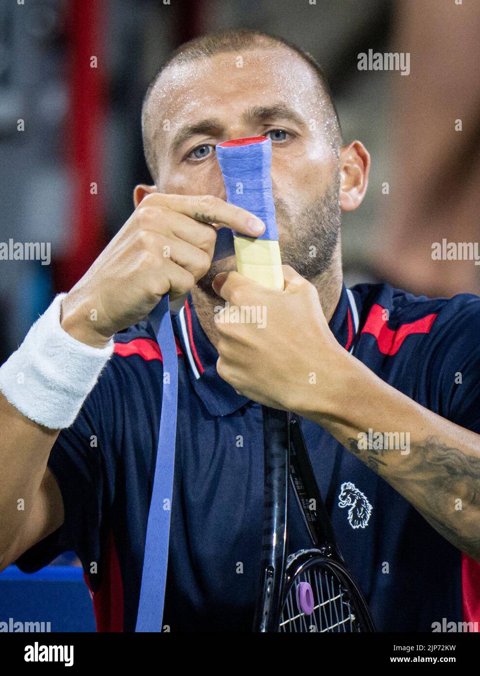 Daniel Evans of Great Britain tapes his racket during his semi-final at ...