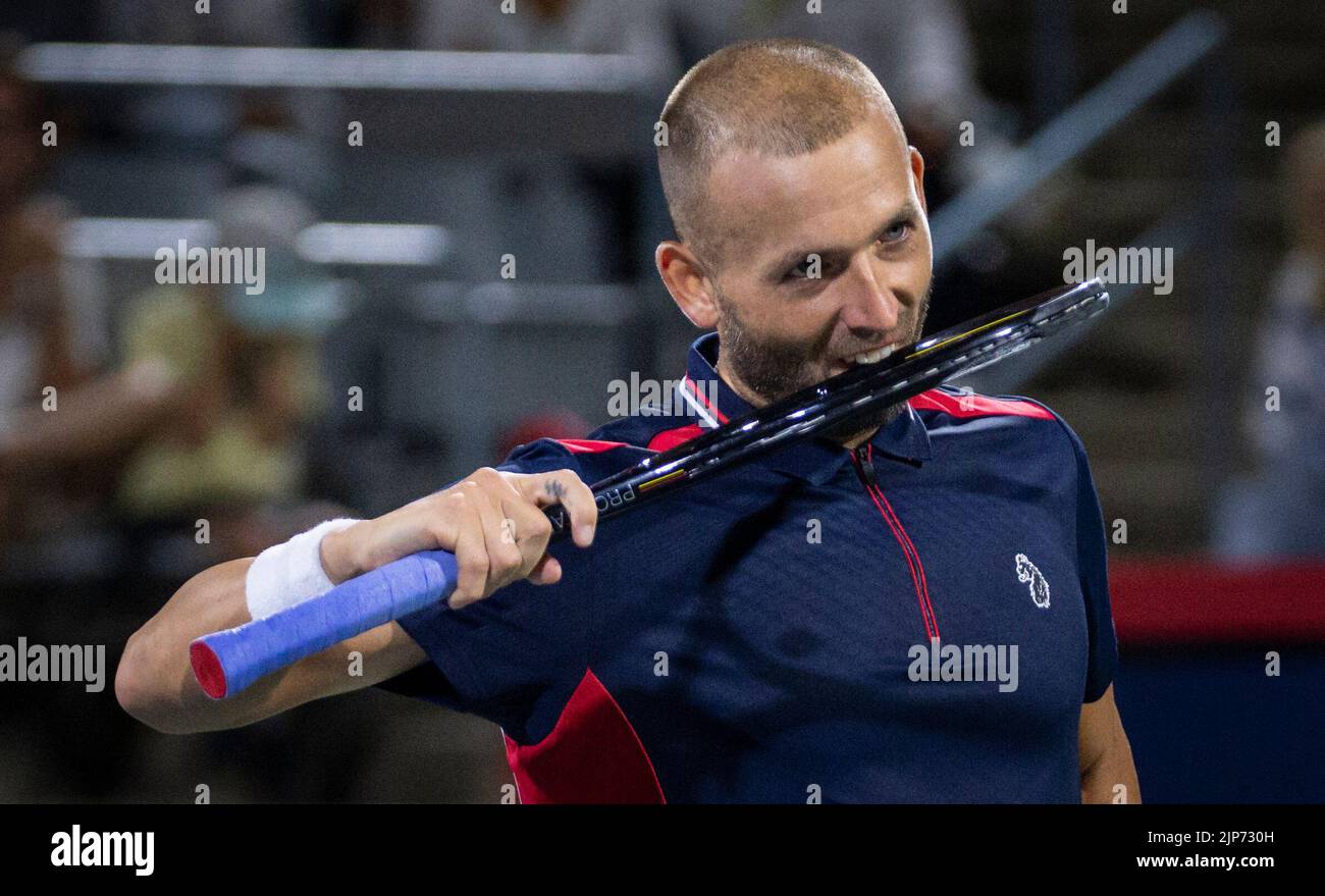 Daniel Evans of Great Britain bites his racket during his semi-final at ...