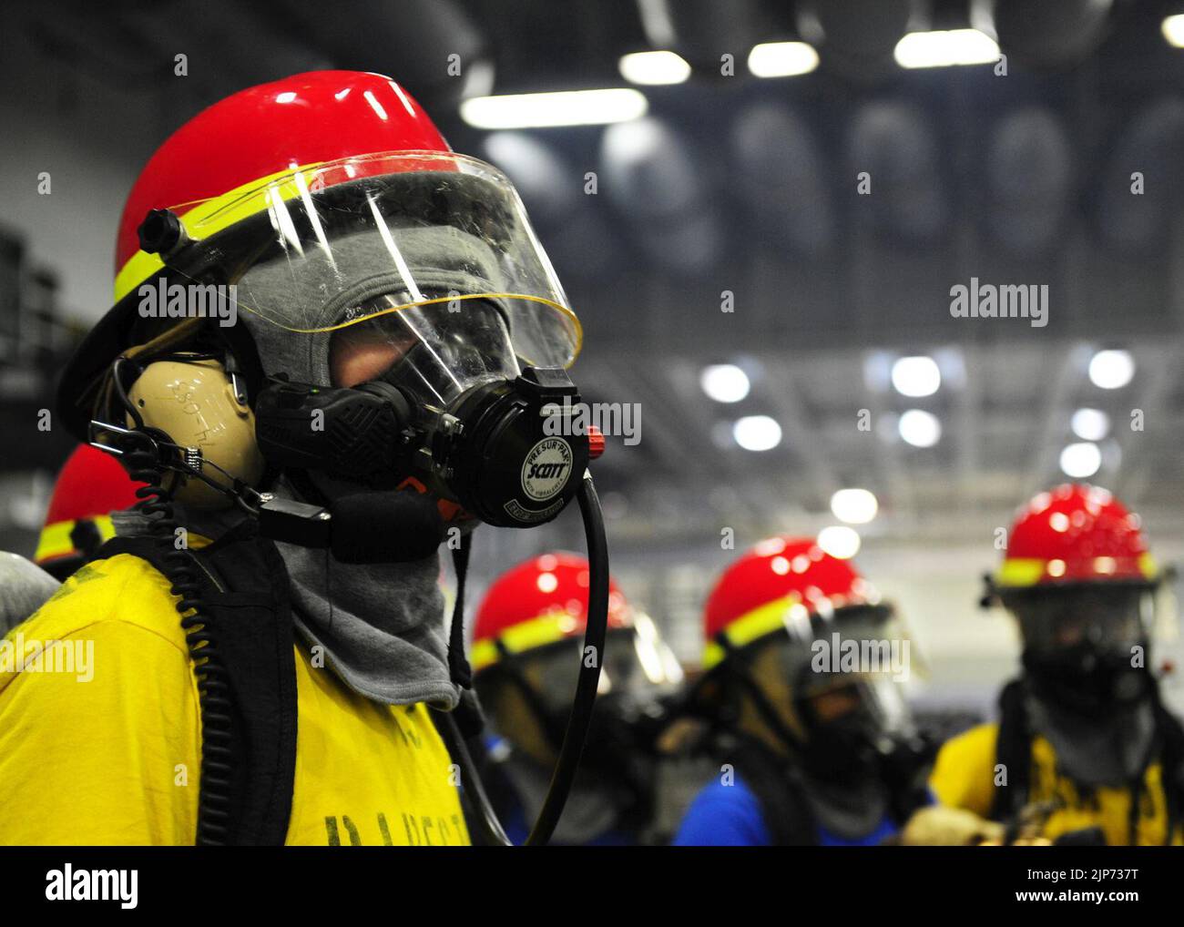 The on-scene leader observes as hose teams fight a simulated aircraft ...