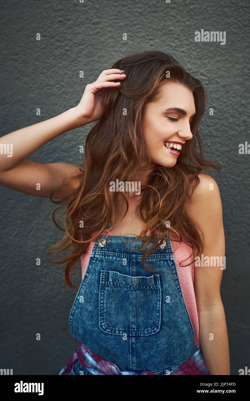 The face of female skateboarders. a cheerful young woman posing against ...