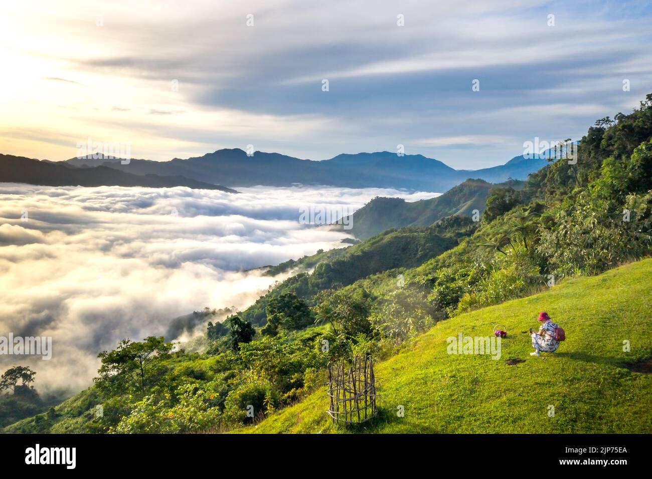 A female tourist looks at the valley full of white clouds in the Tak Po ...