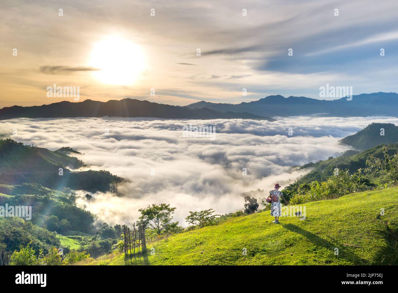 A female tourist looks at the valley full of white clouds in the Tak Po ...
