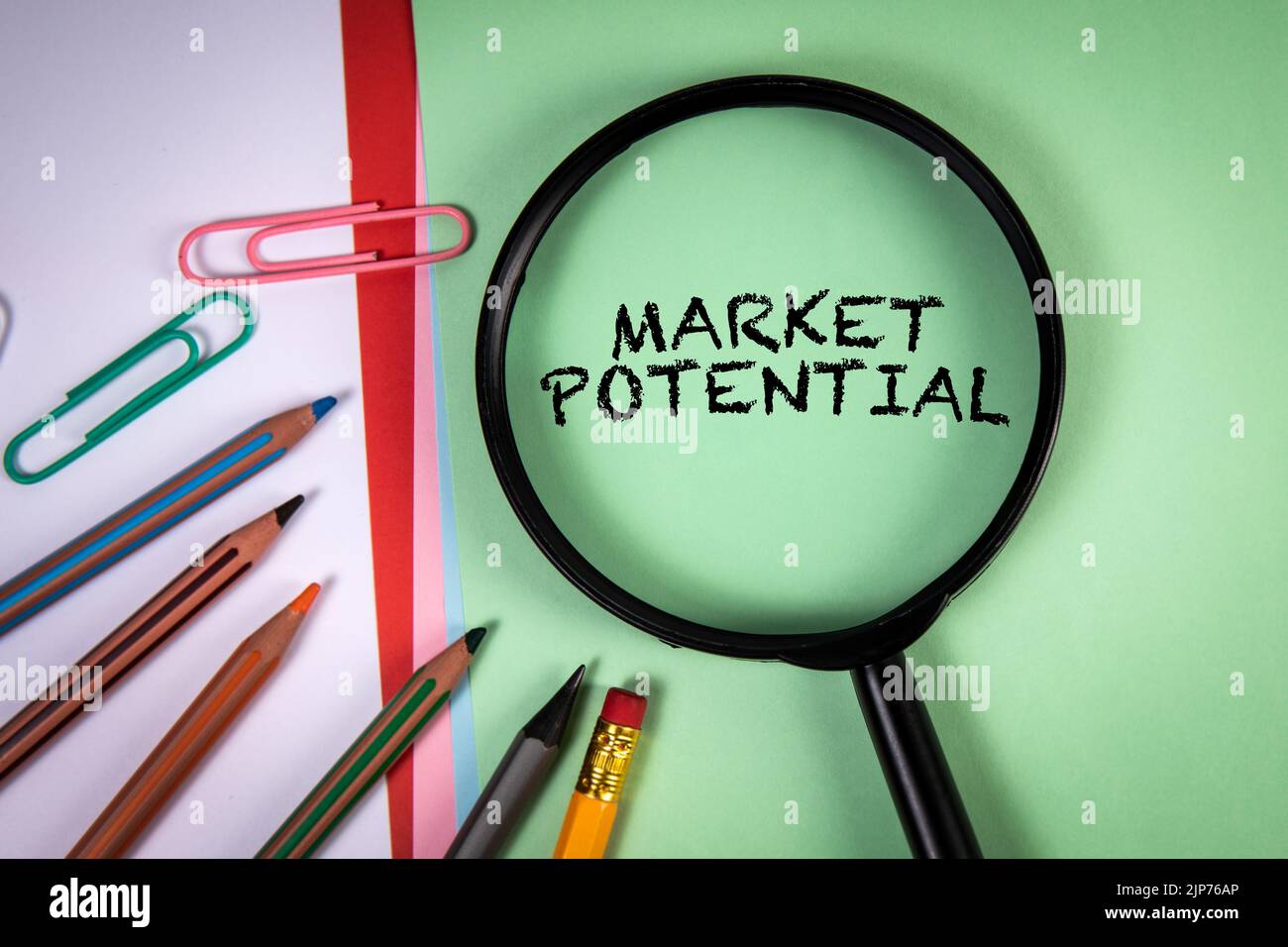 Market Potential concept. Magnifying glass and office objects on a ...