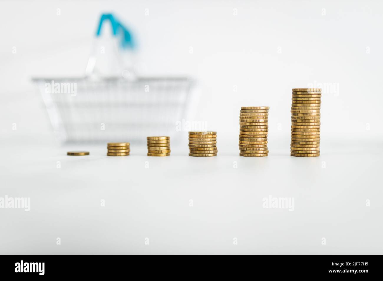 growing stacks of coins representing increasingly expensive prices in ...