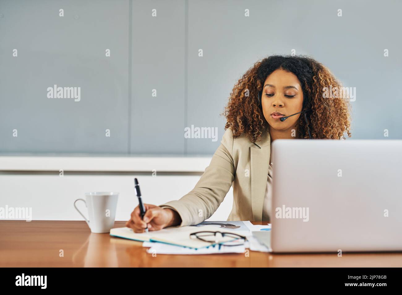 Contacting clients from her home office. a young attractive ...