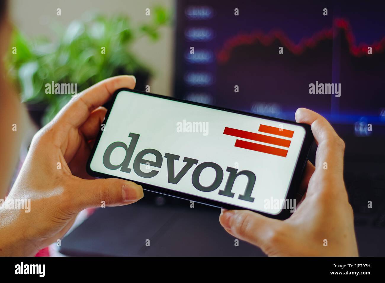 In this photo illustration, the Devon Energy logo is displayed on a ...