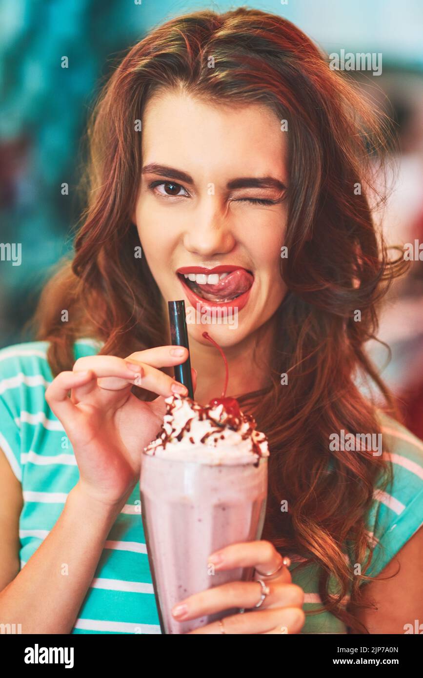Mmmm now that was a yummy milkshake. a beautiful young woman drinking a ...