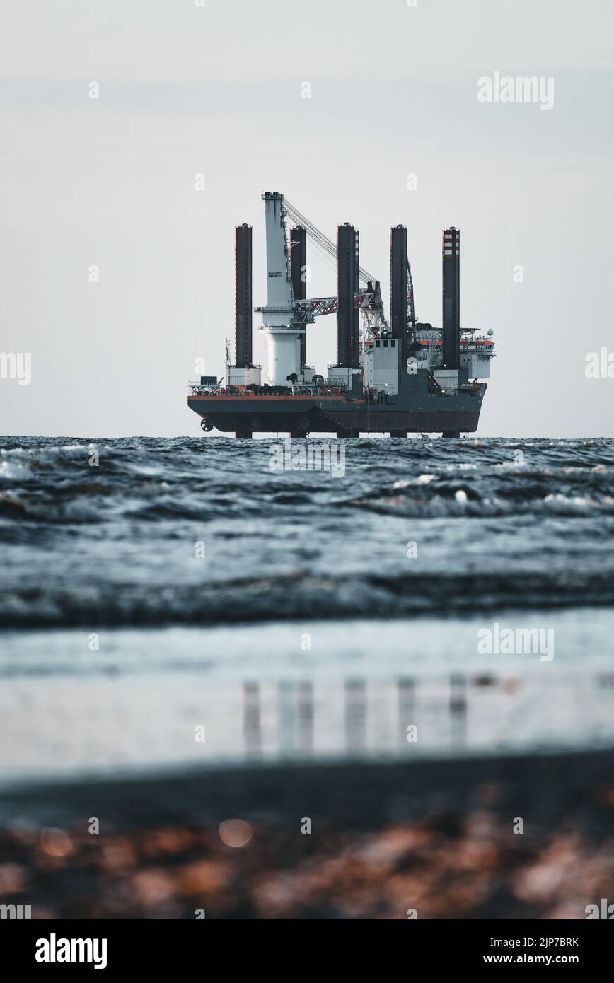 A platform close to the seashore. Industrial image with water around ...